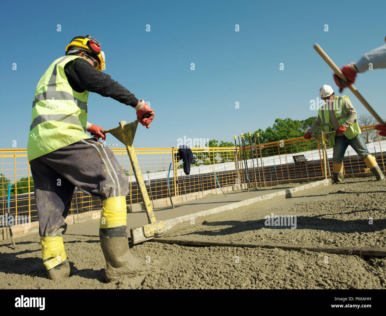 Men levelling concrete Stock Photo - Alamy