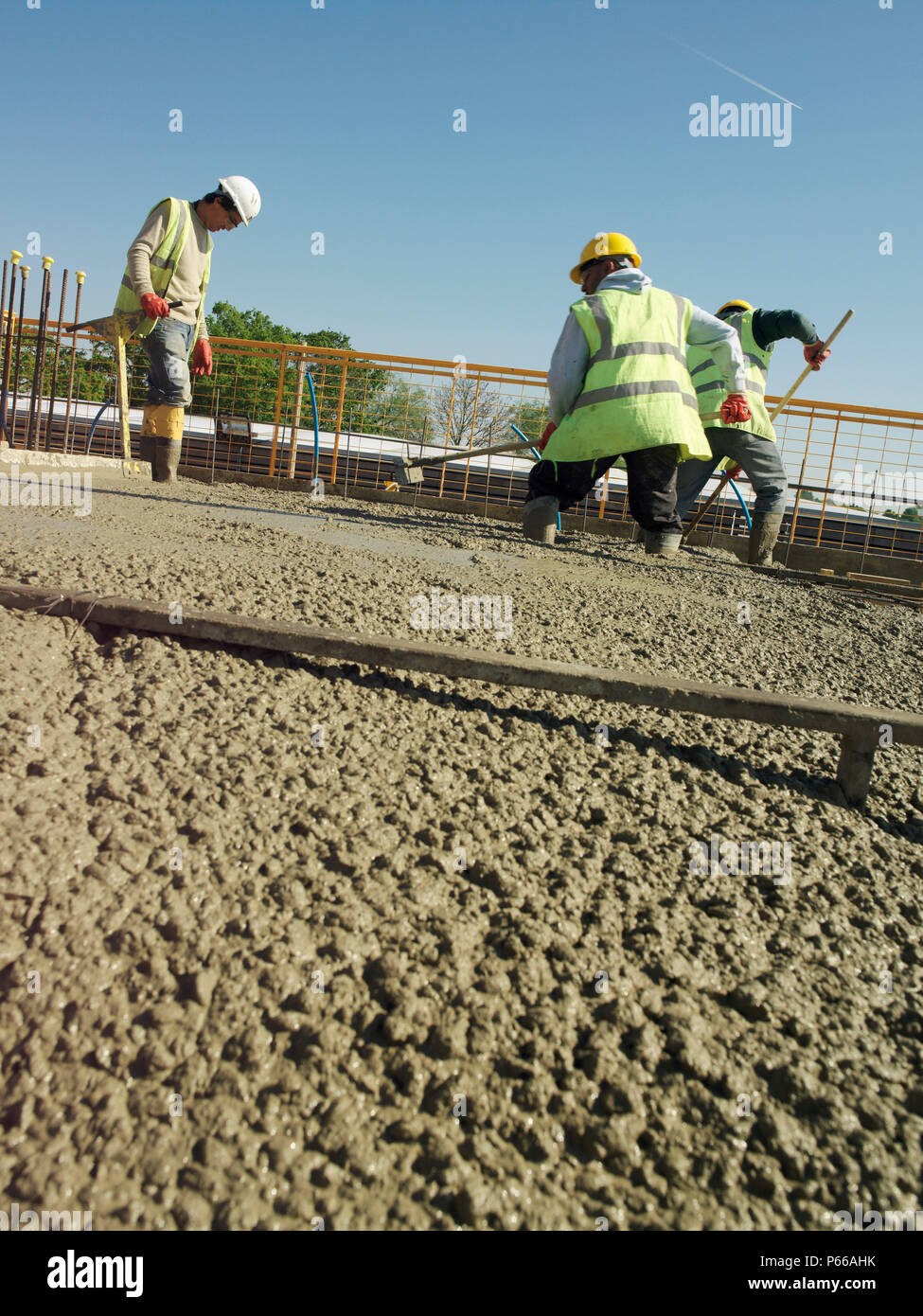 Men levelling concrete Stock Photo - Alamy
