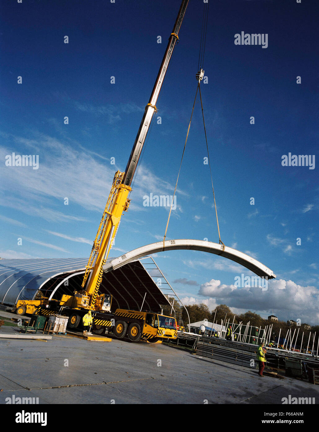 View of a crane lifting steelwork on a building site Stock Photo - Alamy