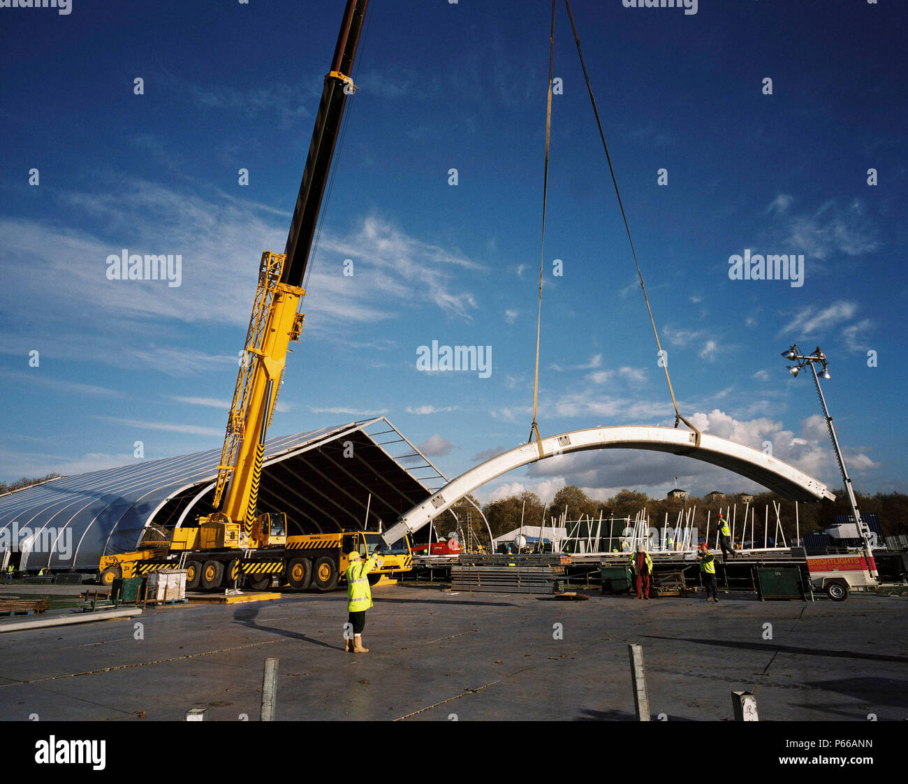 View of a crane lifting steelwork on a building site Stock Photo - Alamy