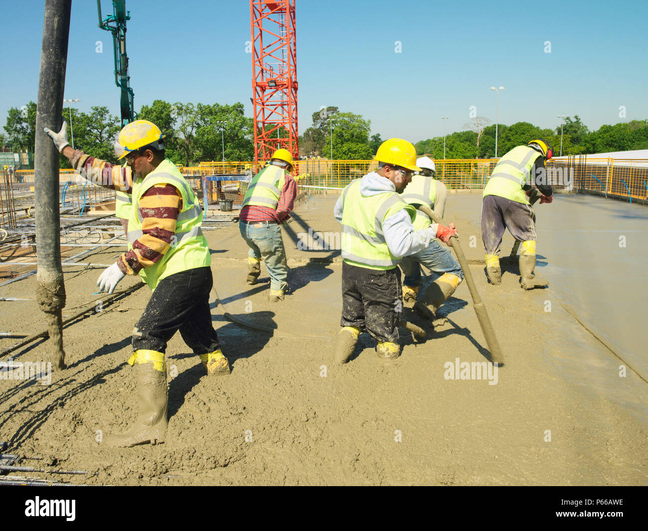 Construction workers laying down concrete Stock Photo - Alamy