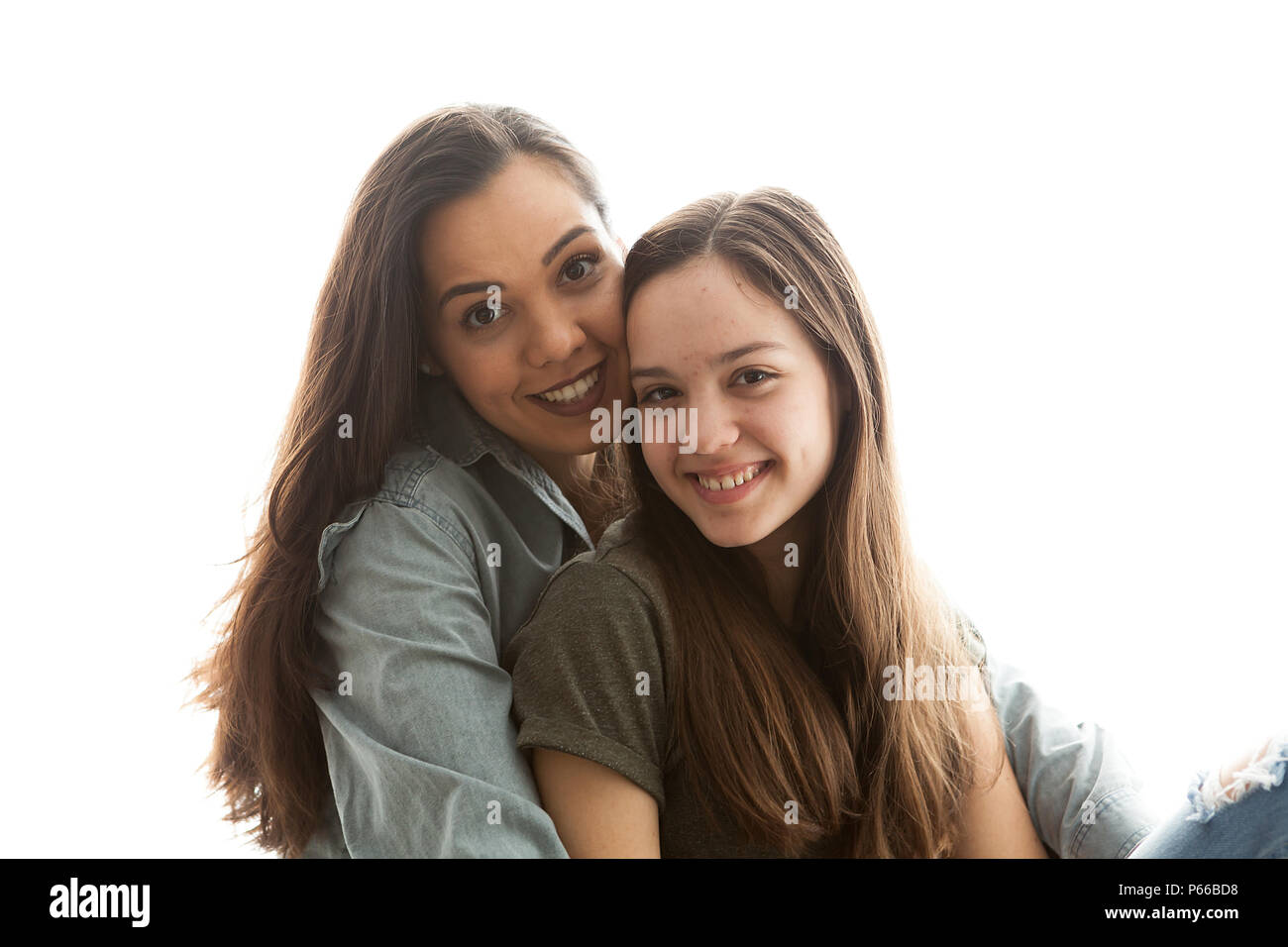 Portrait of two sisters next to a big bright window Stock Photo - Alamy