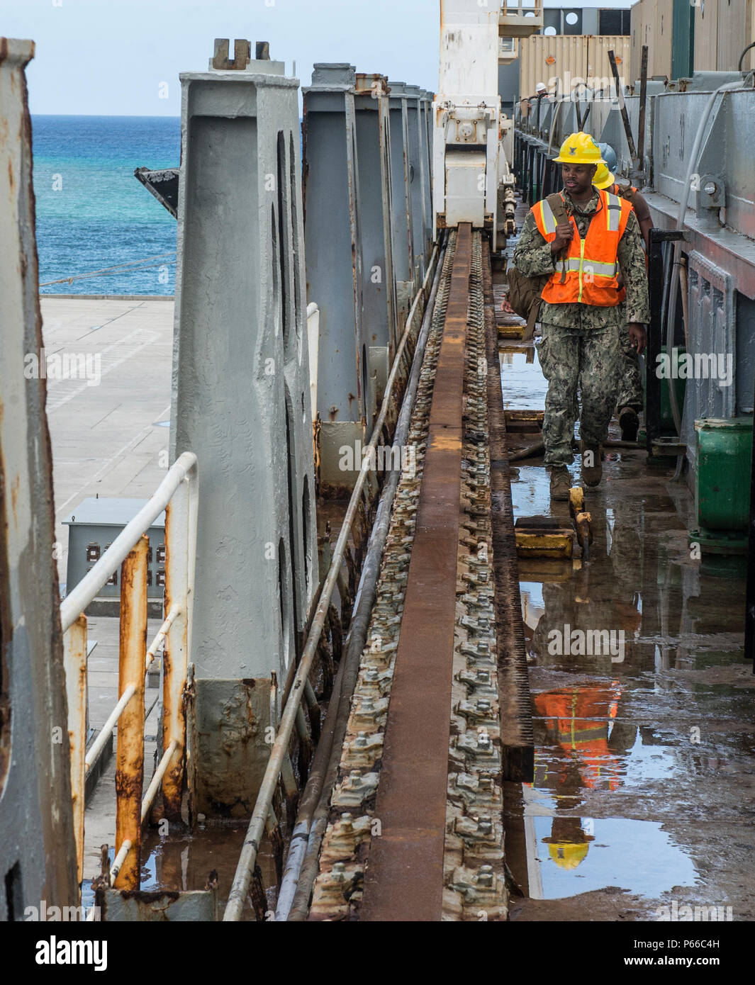 Sailors assigned to Navy Cargo Handling Battalion (NCHB) 1 disembark U ...