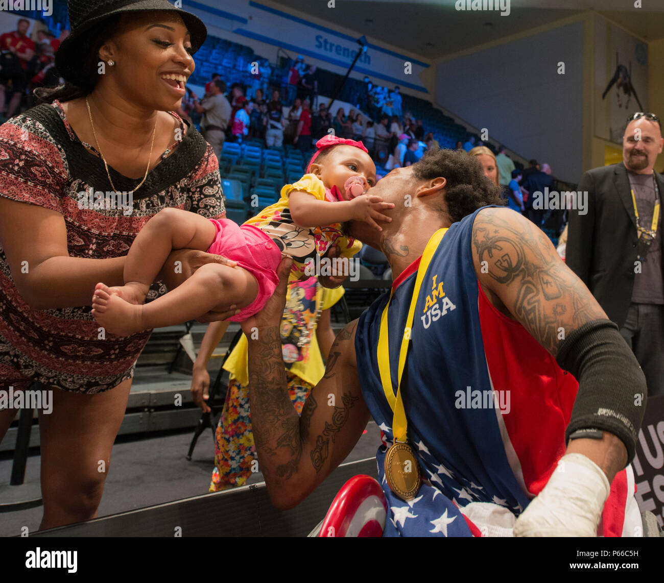 U.S. Marine Corps veteran Anthony McDaniel kisses his daughter after ...