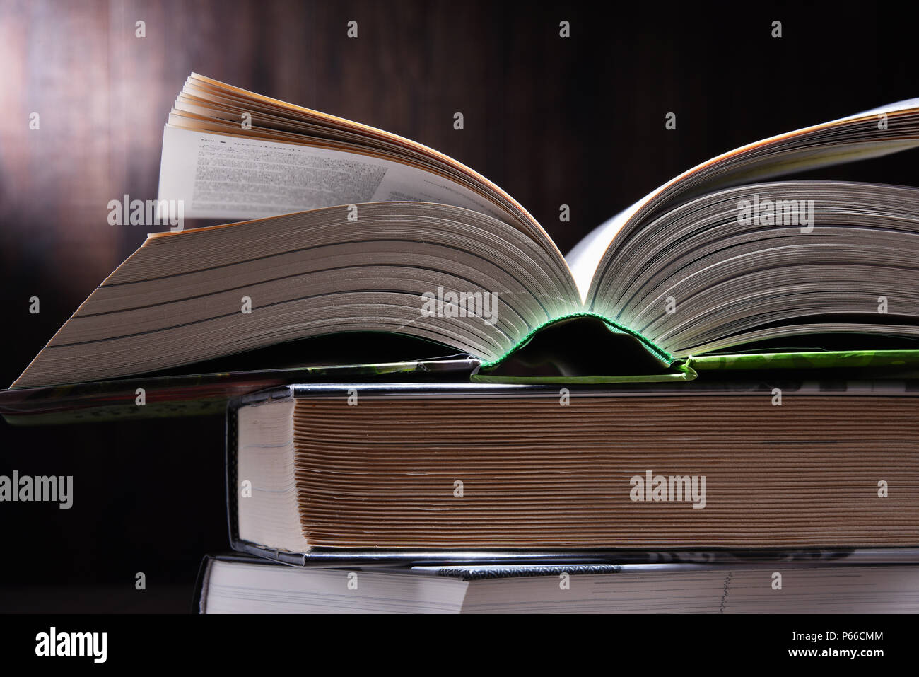 Composition with open book on the table Stock Photo - Alamy