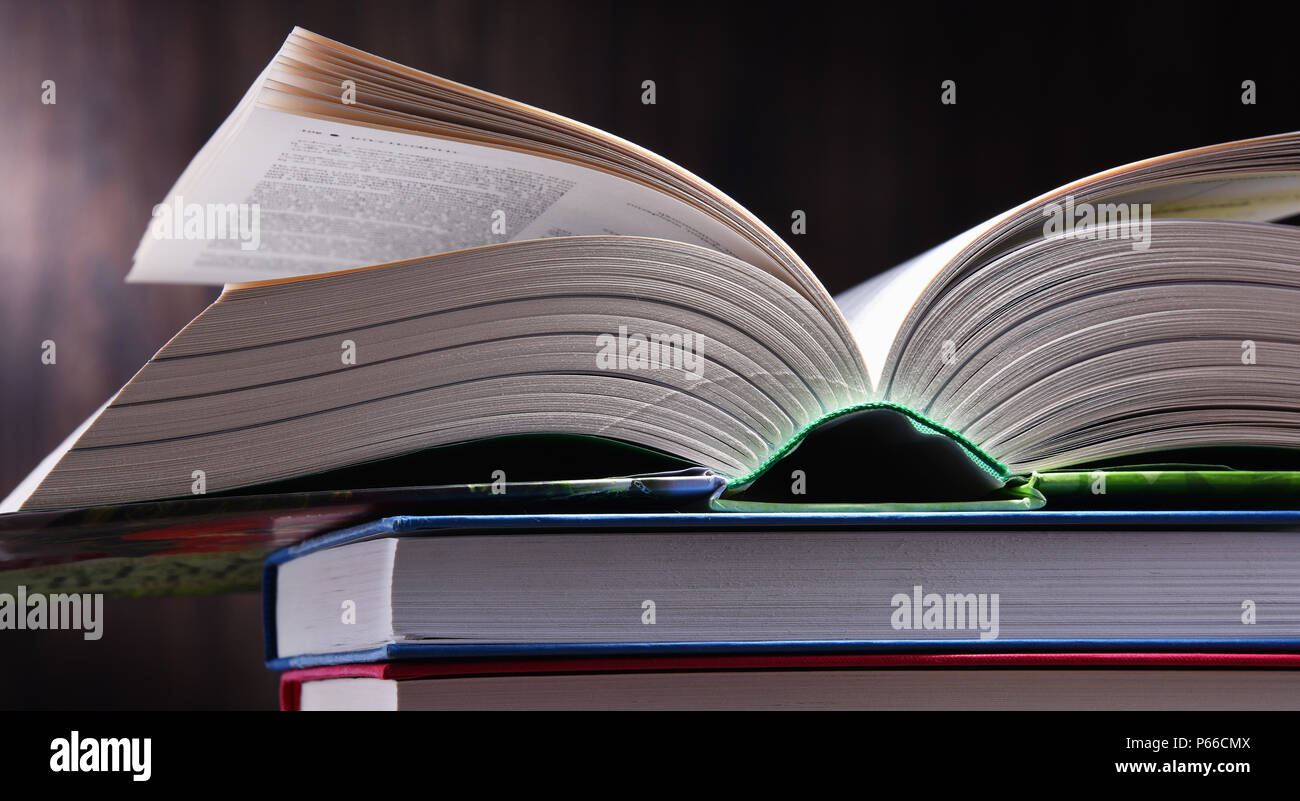 Composition with open book on the table Stock Photo - Alamy