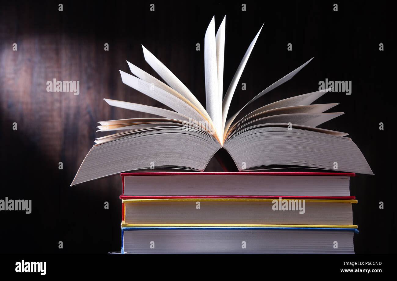 Composition with open book on the table Stock Photo - Alamy