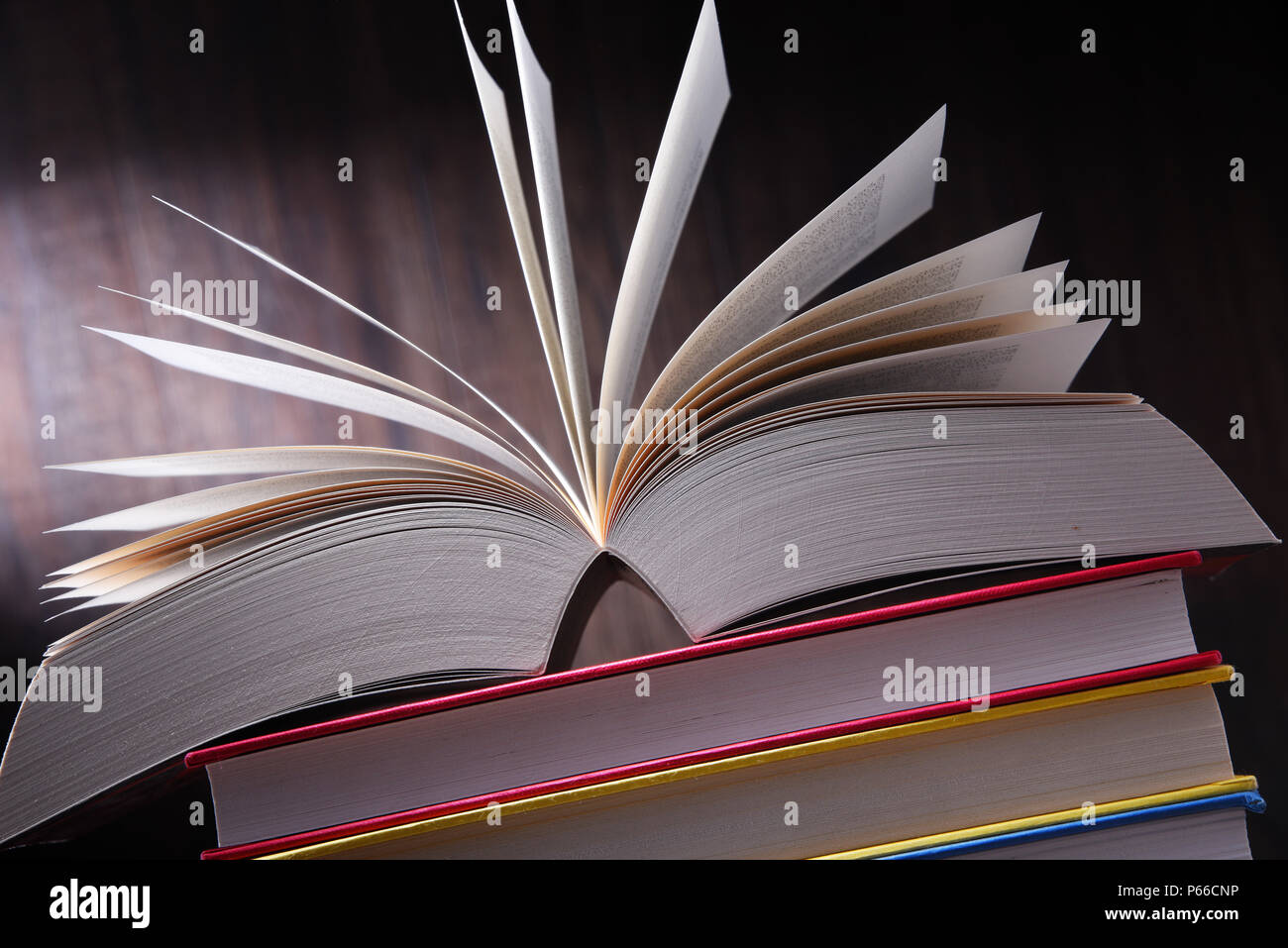 Composition with open book on the table Stock Photo - Alamy