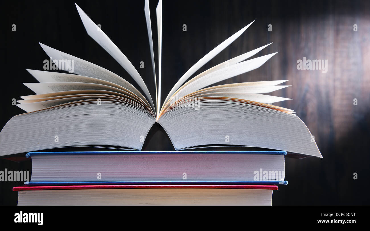 Composition with open book on the table Stock Photo - Alamy