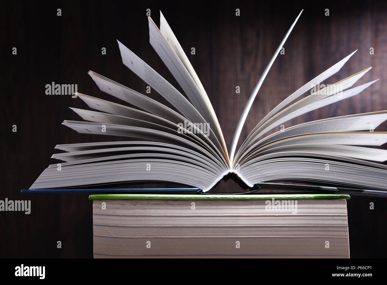 Composition with open book on the table Stock Photo - Alamy