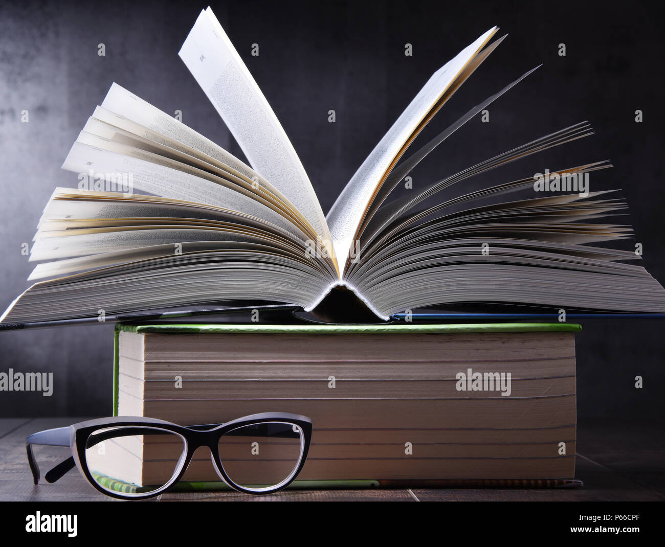 Composition with open book on the table Stock Photo - Alamy