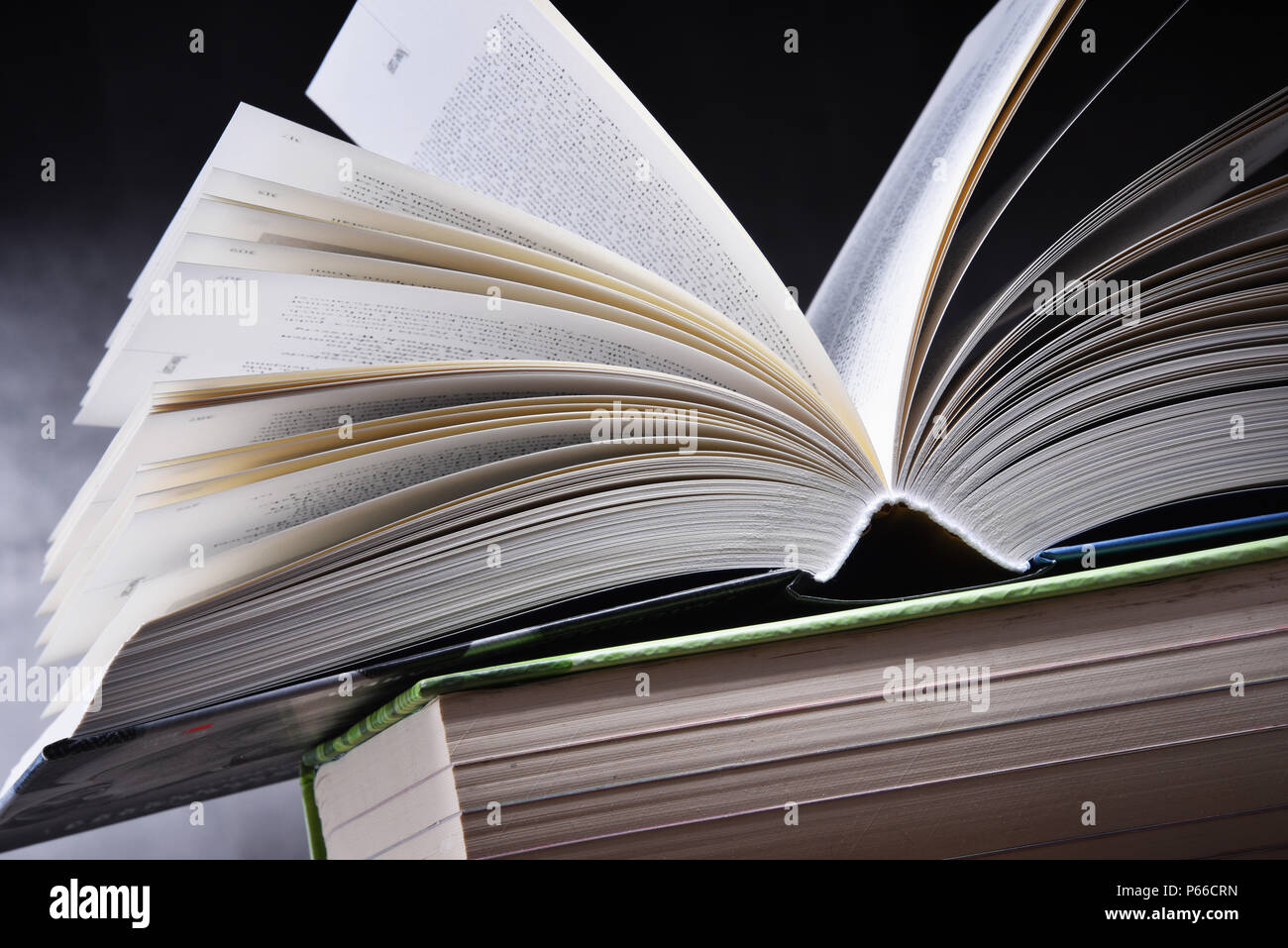 Composition with open book on the table Stock Photo - Alamy