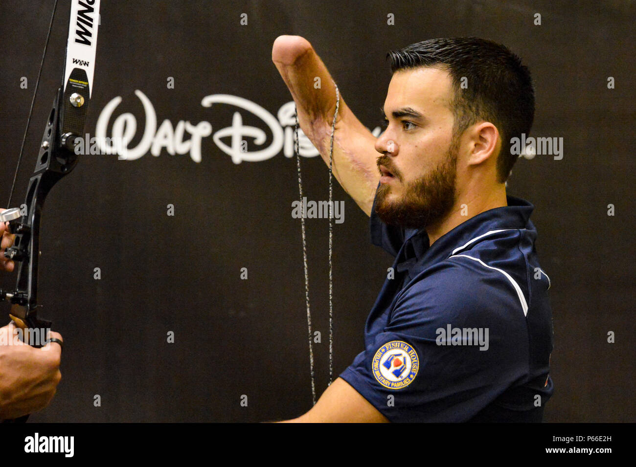 Retired U.S. Air Force Staff Sgt. Daniel Crane helps a teammate string ...