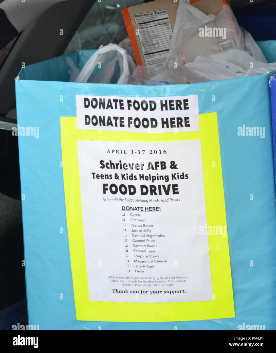 A food collection box sits in the trunk of a vehicle outside the ...