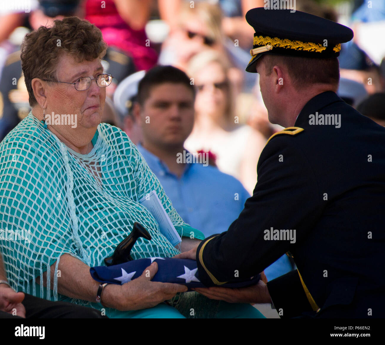 Beverly Van Alst, sister of Pvt. Clinton Mullenix, receives a folded ...