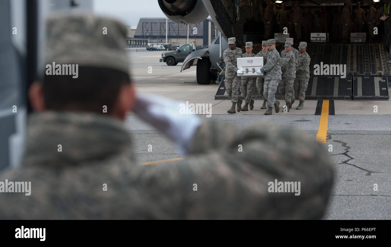 A U.S. Air Force carry team carries an empty transfer case at the ...