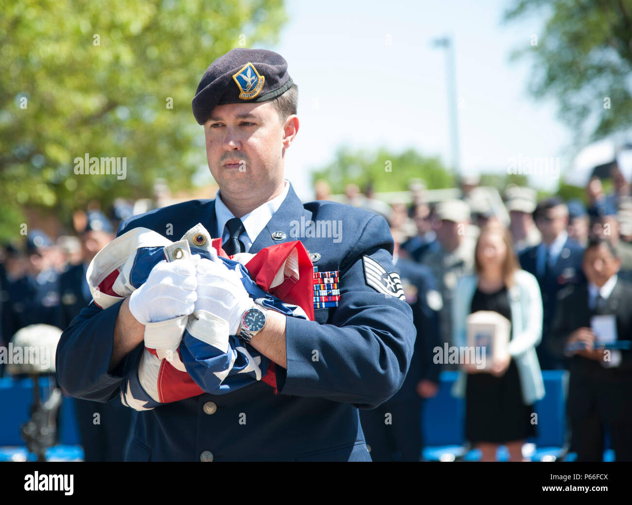 Tech. Sgt. Jeffrey Long clutches the colors at a memorial service for ...