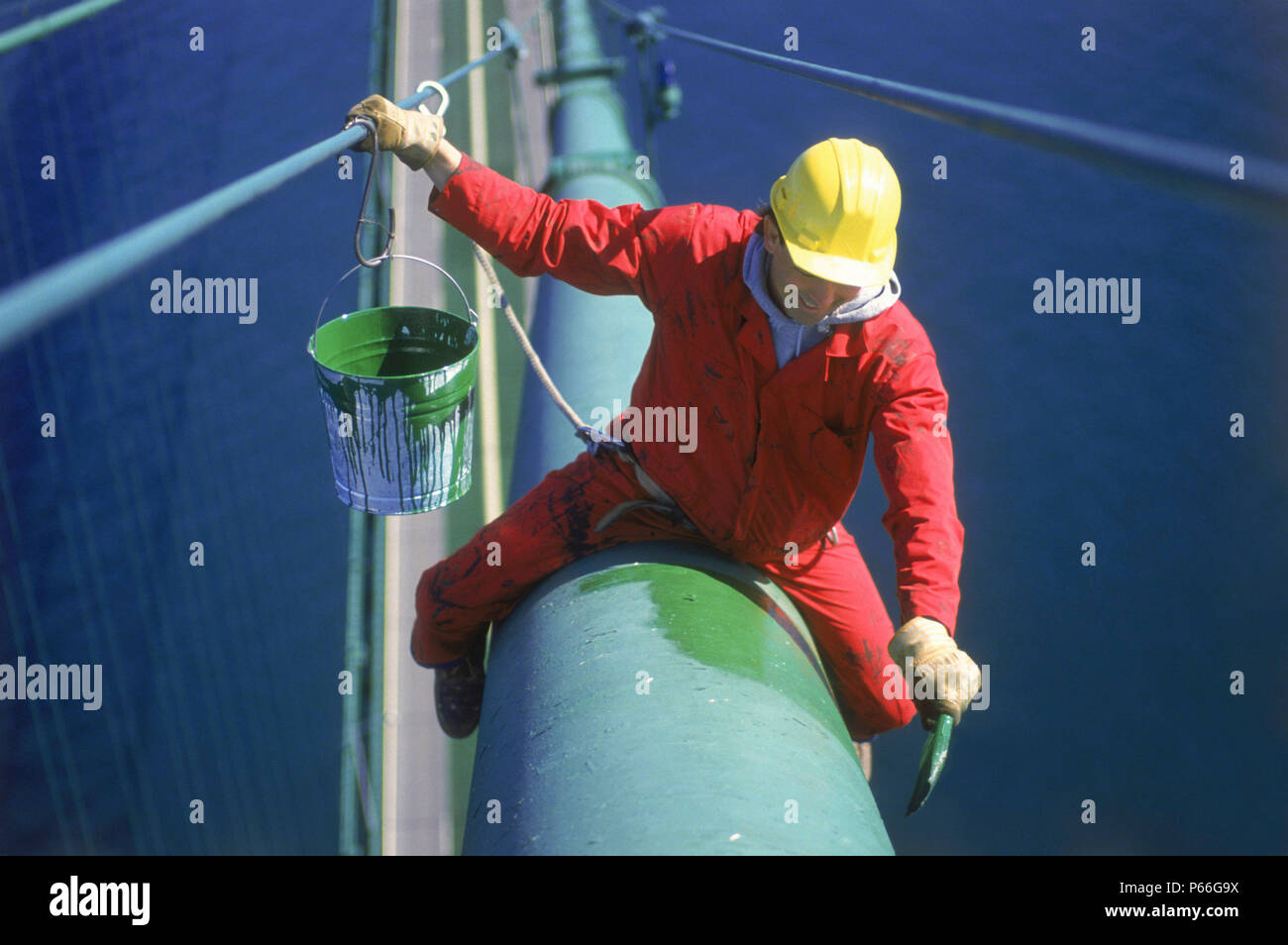 Man Painting Cable of Suspension Bridge Stock Photo - Alamy