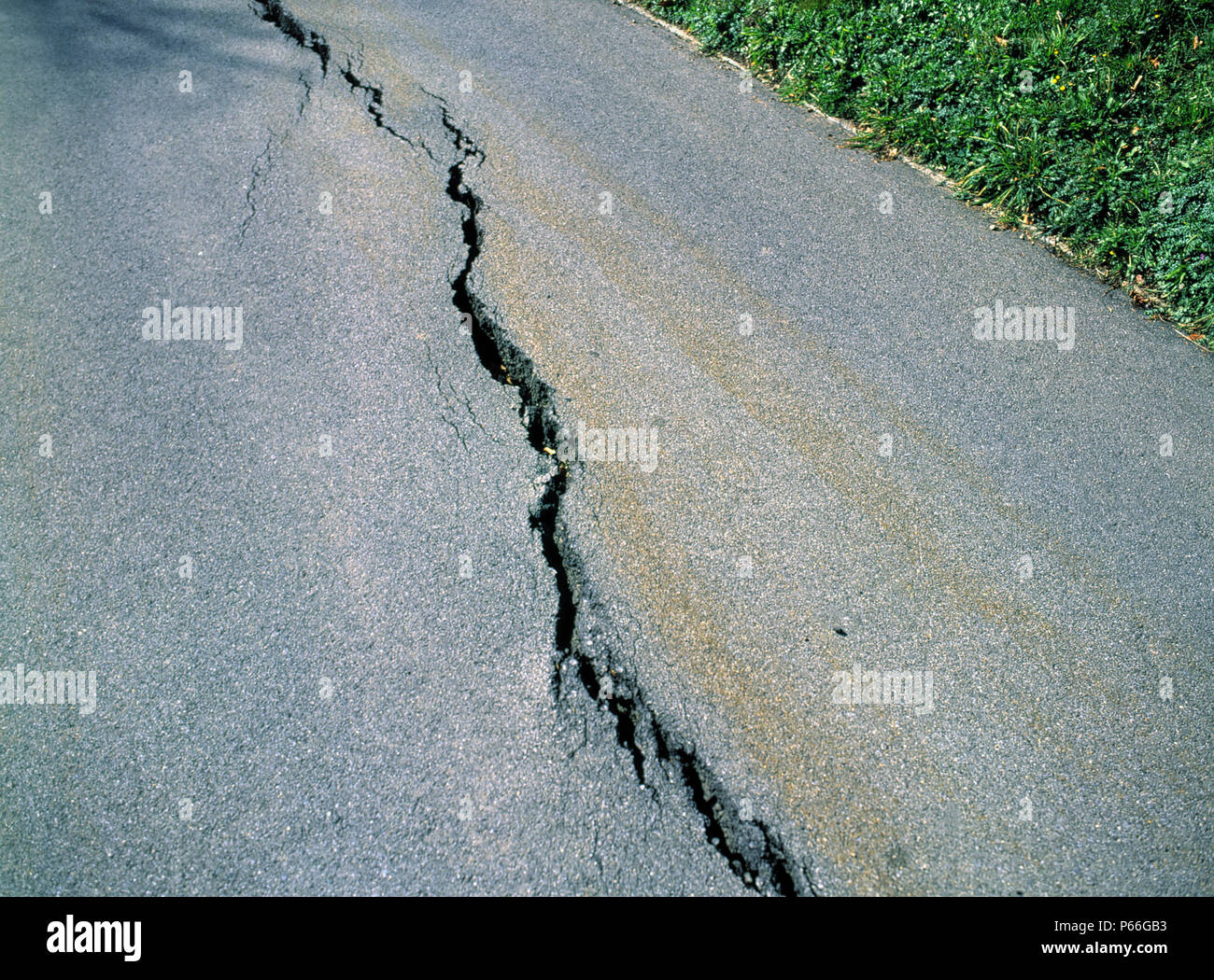 Gap cutting through paved road following an earthquake Stock Photo - Alamy