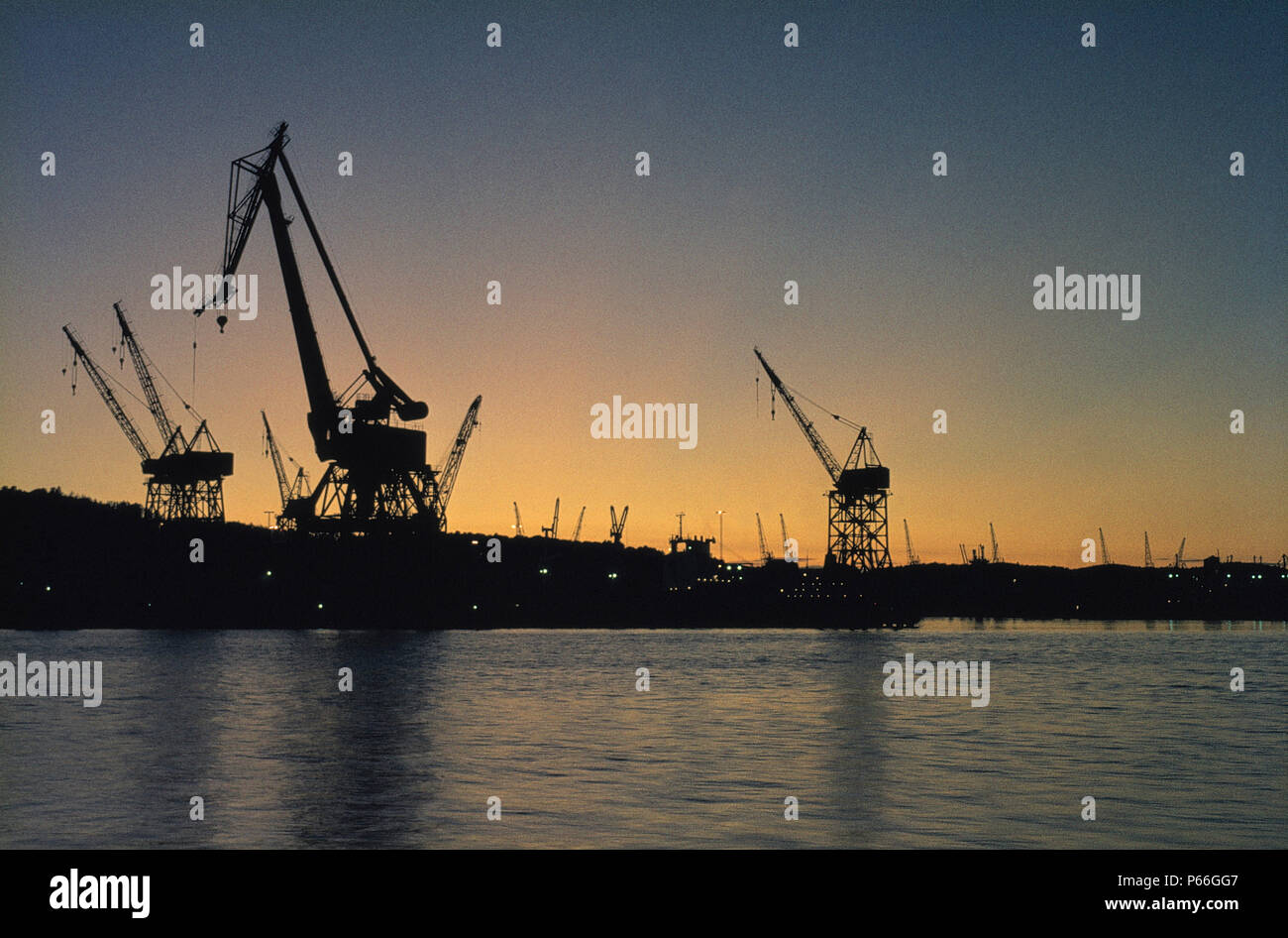 Loading docks at sunset, harbour Stock Photo - Alamy