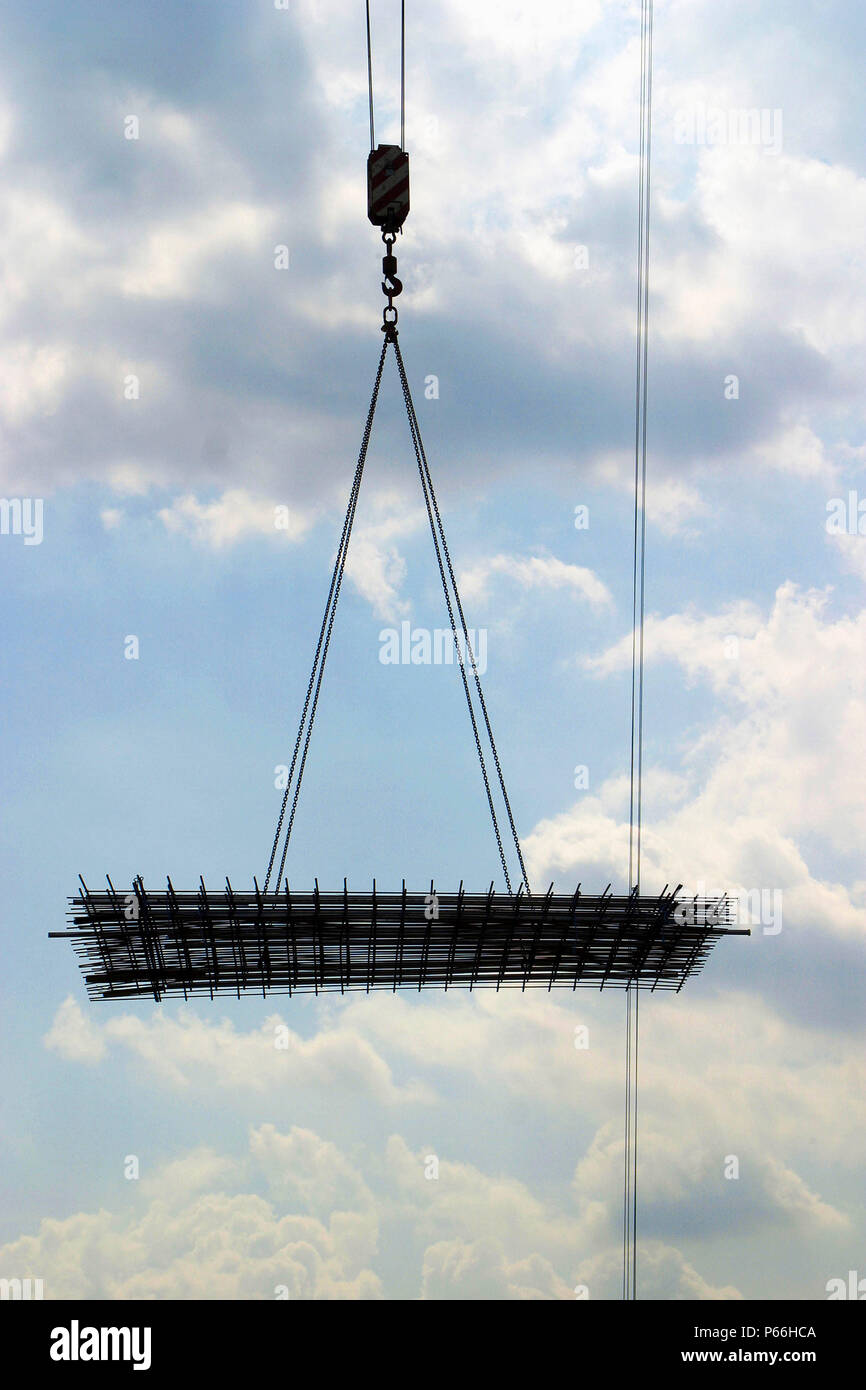 Crane lifting building material Stock Photo - Alamy