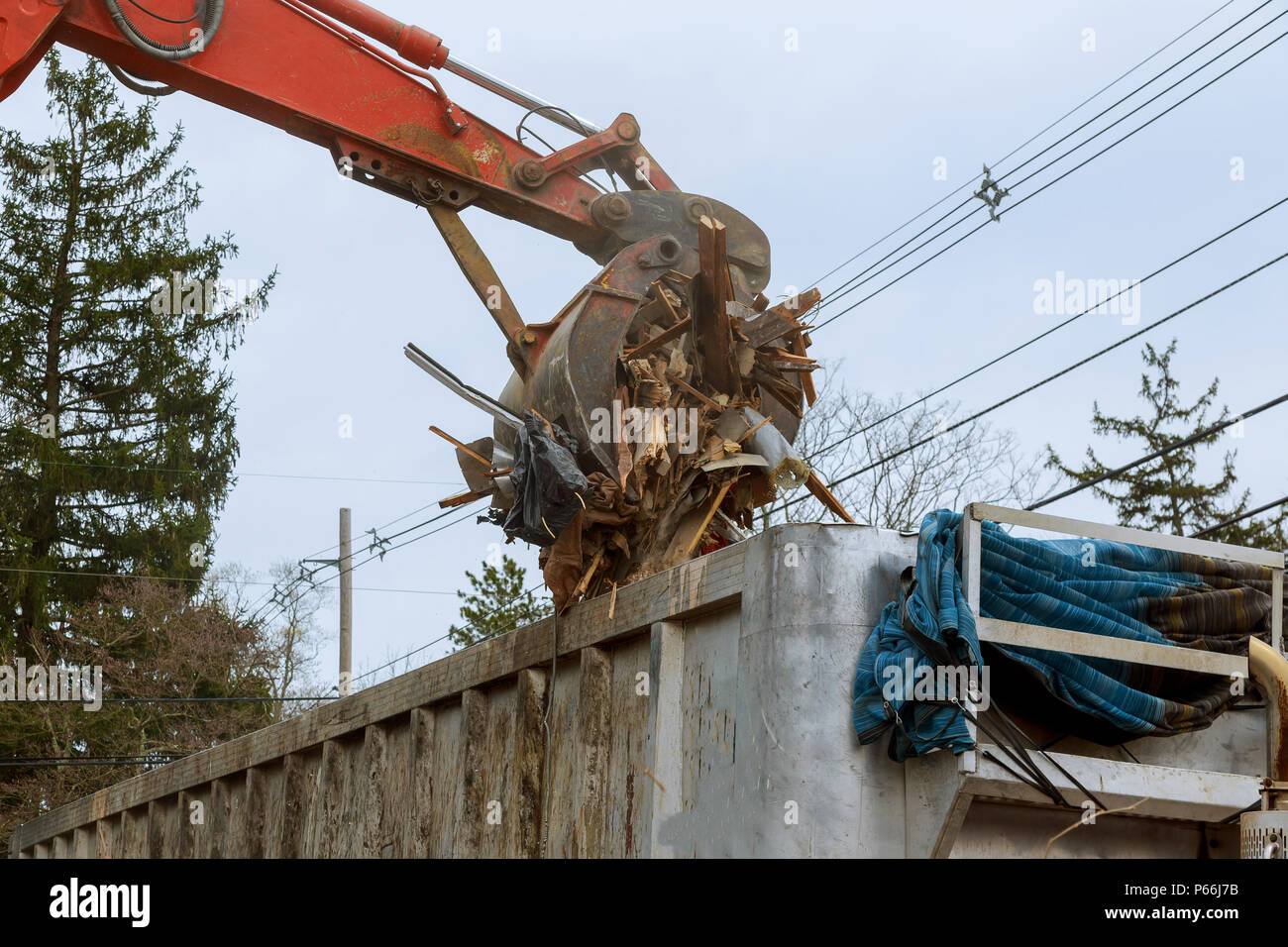Demolition of houses by hydraulic crashers Buried house is broken brick ...