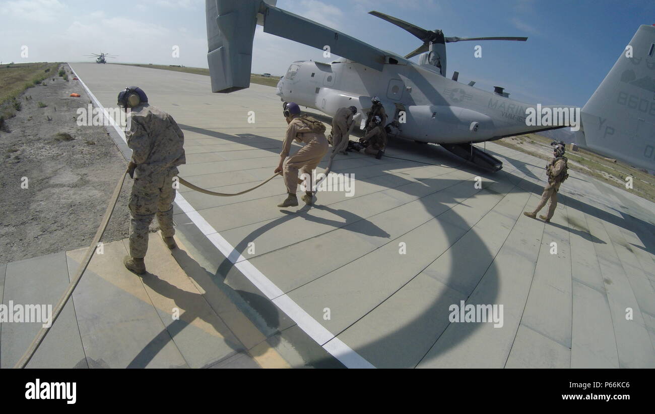 Marines fuel an MV-22 Osprey at a Forward Armament and Refueling Point ...