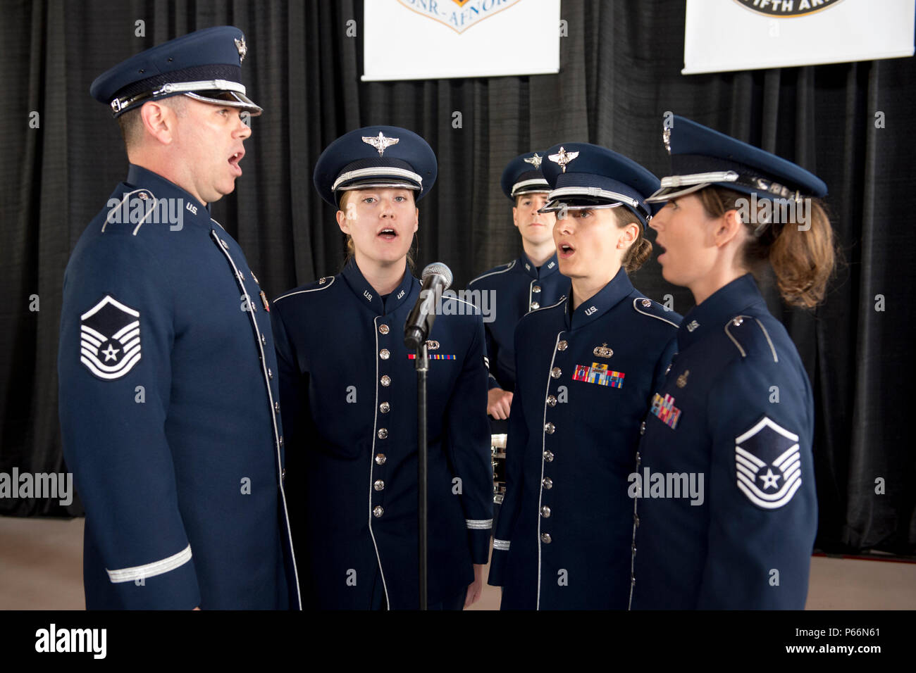 Members of the U.S. Air Force Academy Band sing the national anthem at ...