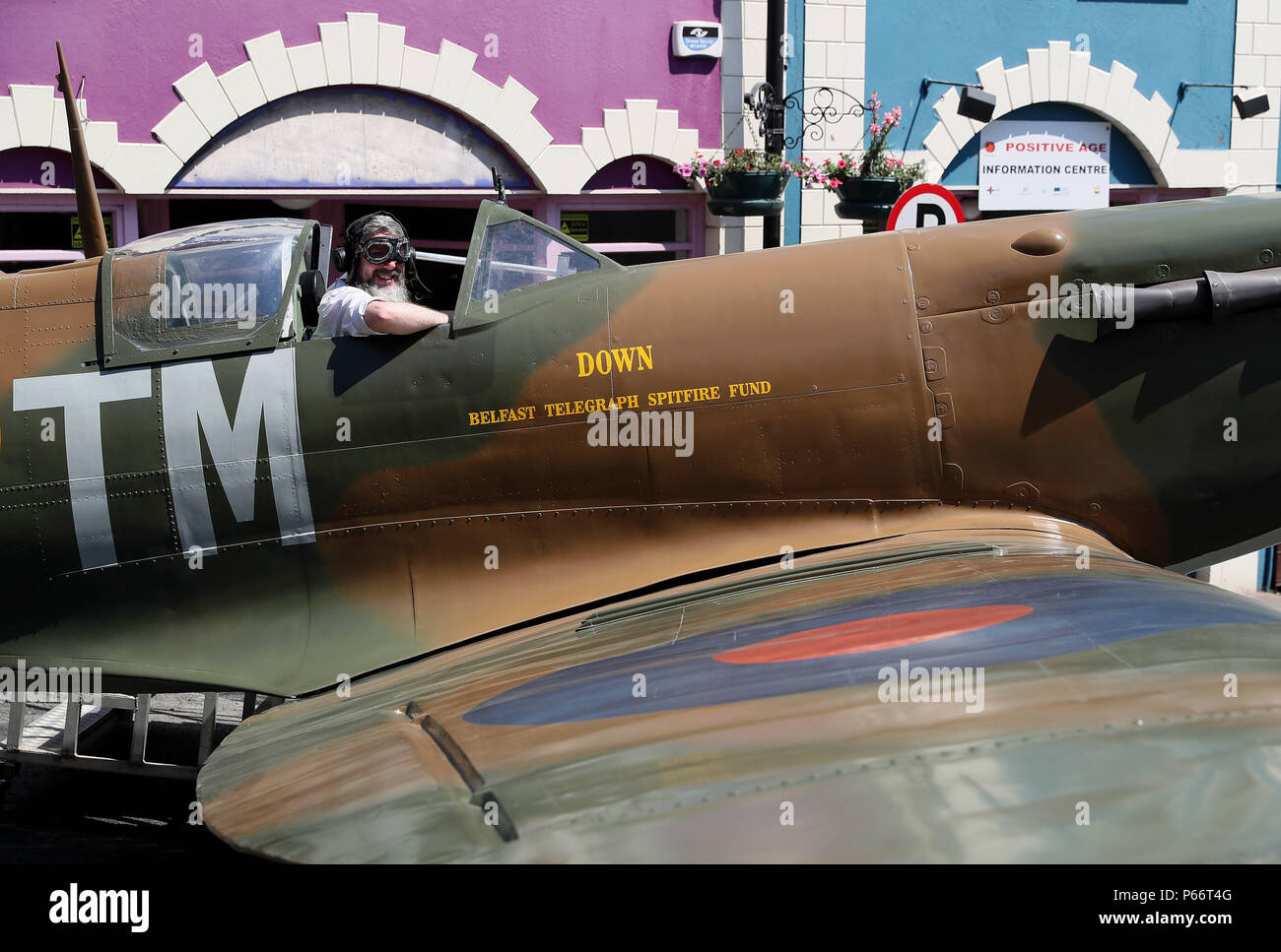 A man sits in the cockpit of a replica spitfire as the exhibition 'The ...