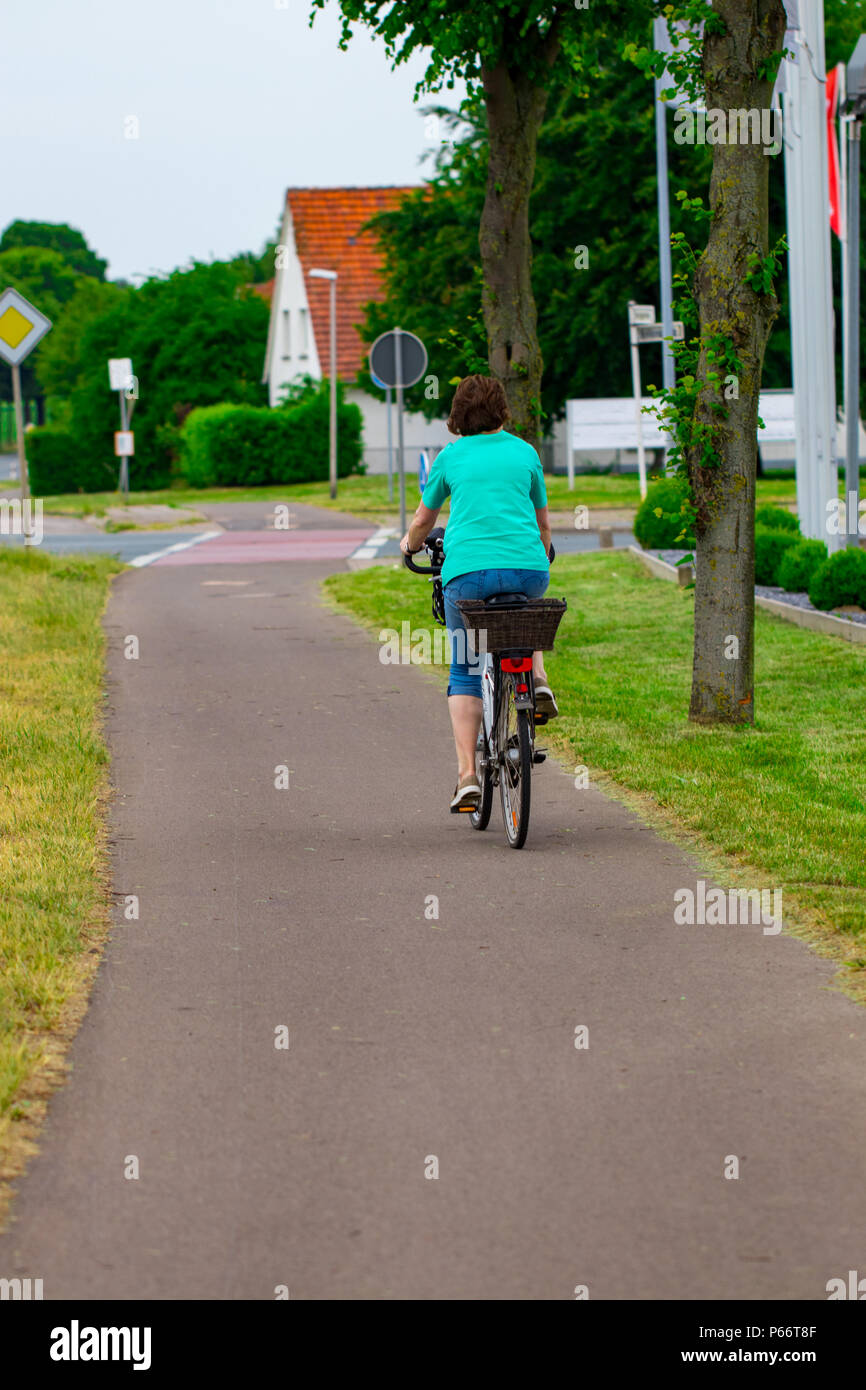 Young woman riding a bike, back view Stock Photo - Alamy