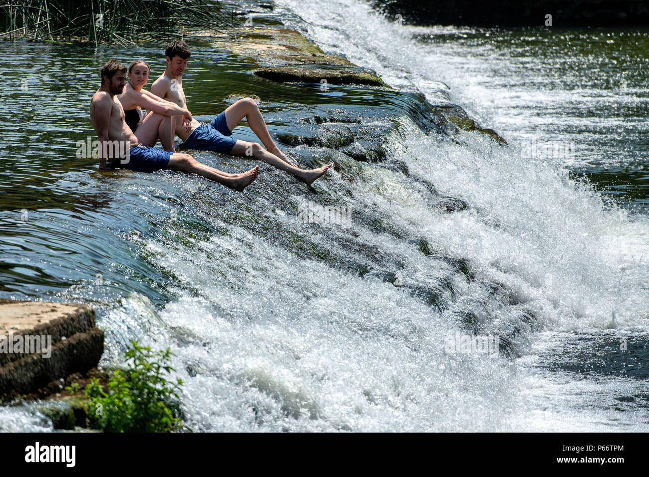 People cool down in the river Avon next to the weir at Bathampton Mill ...