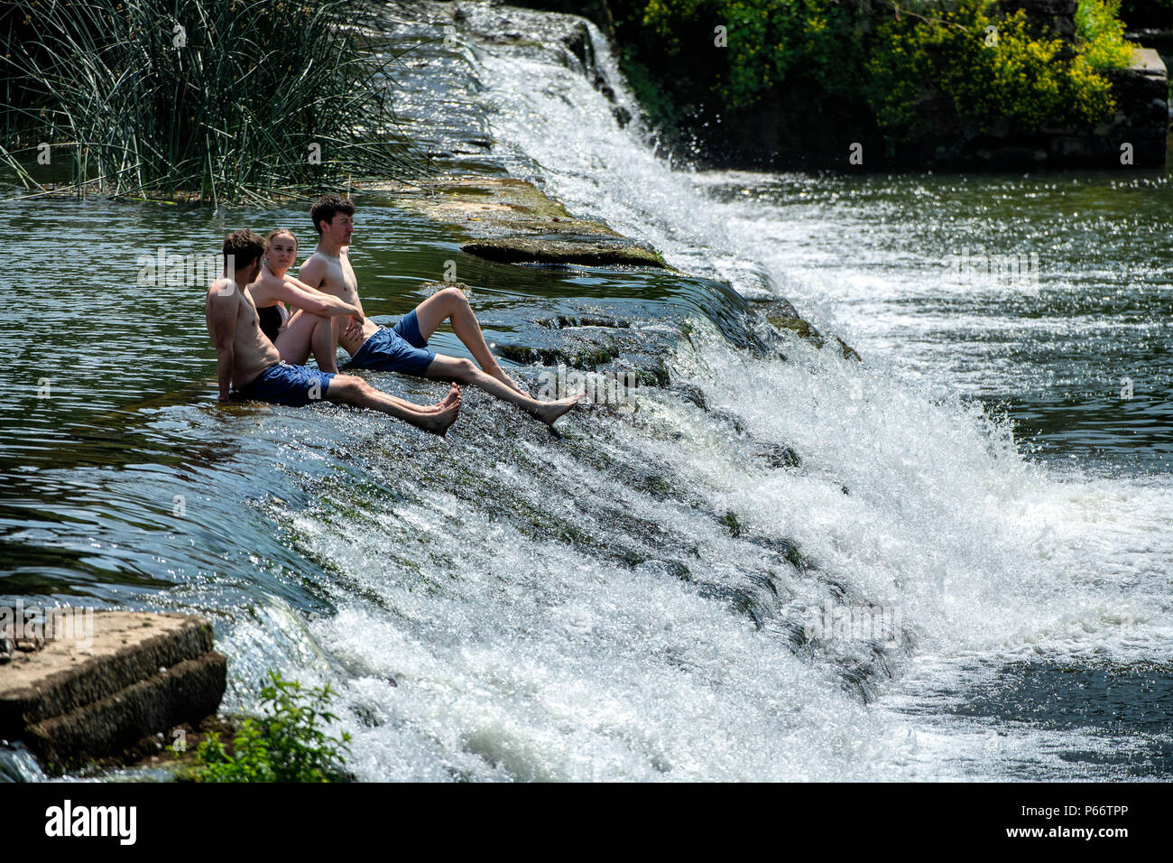 People cool down in the river Avon next to the weir at Bathampton Mill ...