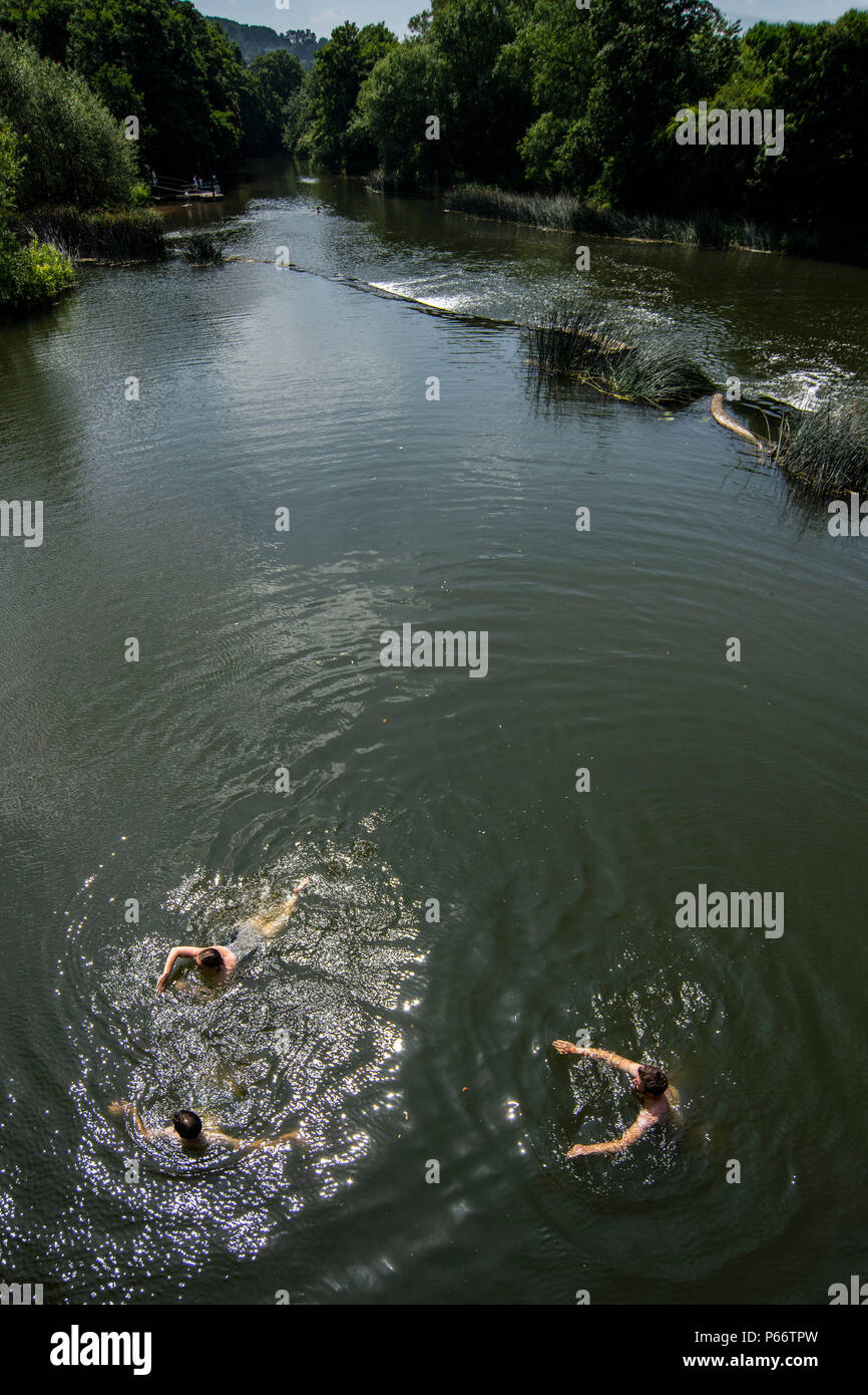 People cool down in the river Avon next to the weir at Bathampton Mill ...