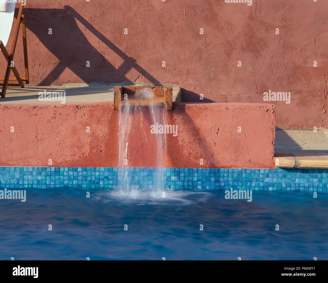 View of water gushing into the swimming pool Stock Photo - Alamy