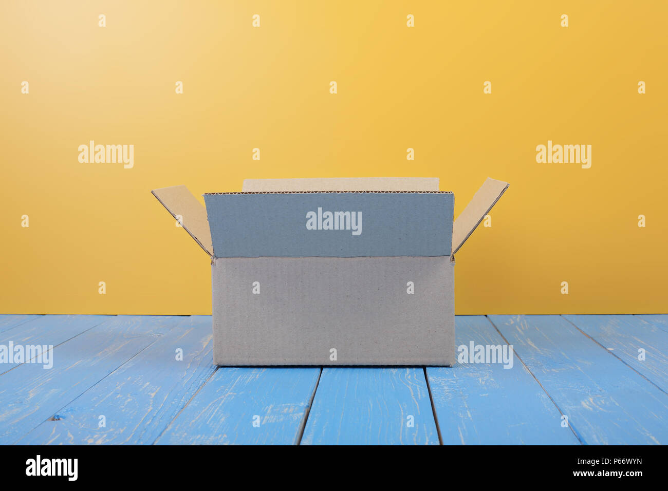 Postage and packing service - Open Package front view on a blue wood ...