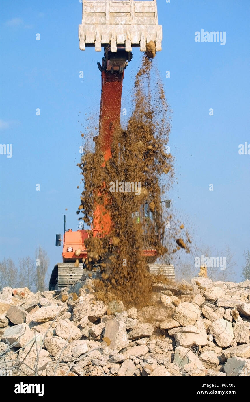 Tracked excavator digging earth on a brownfield site Stock Photo - Alamy