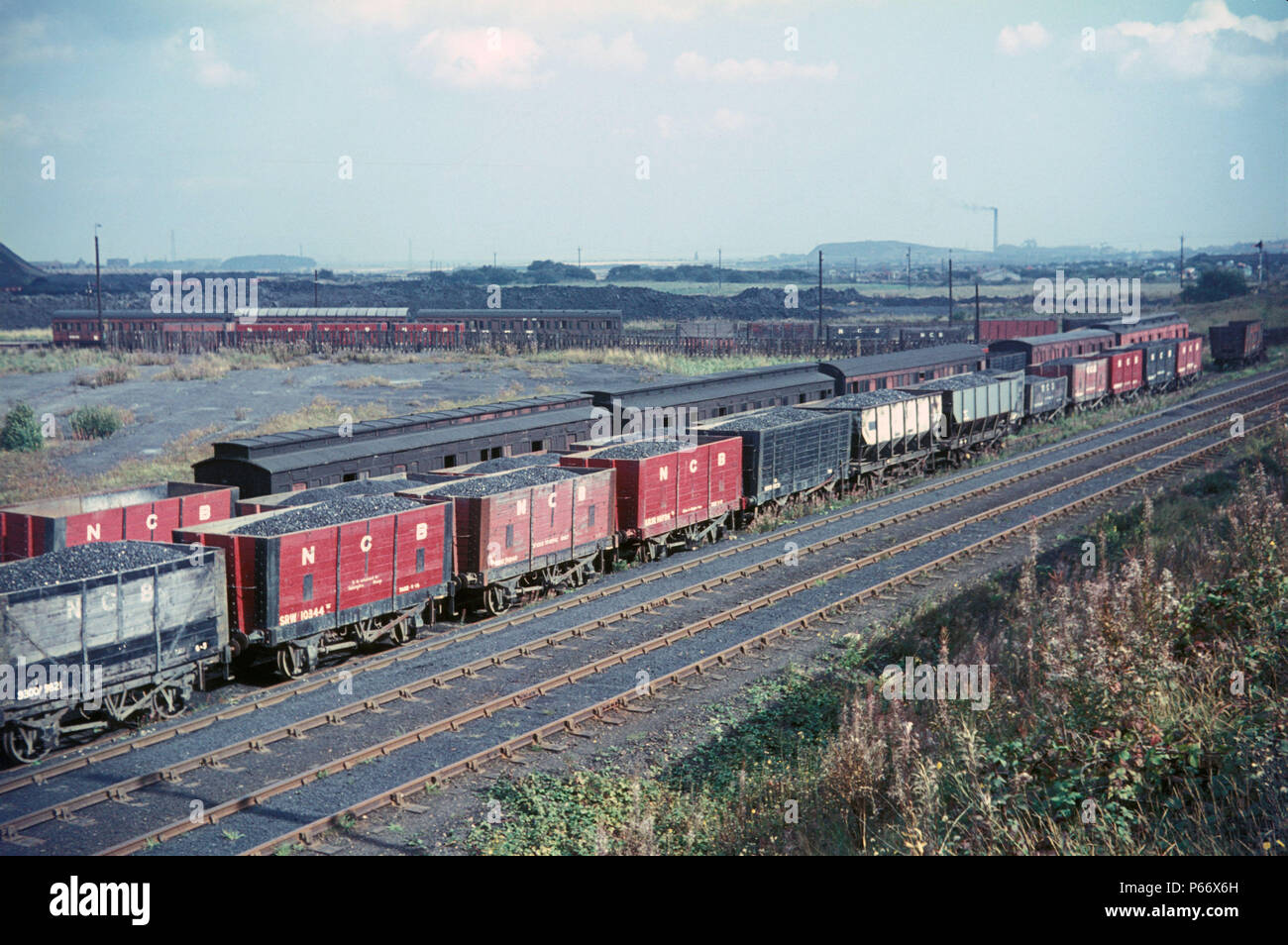A rake of loaded coal wagons and pre-grouping clerestory coaching stock ...