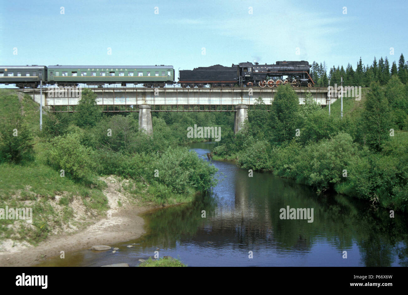 A Russian LV Class, 2-10-2 crosses a river with a special passenger ...