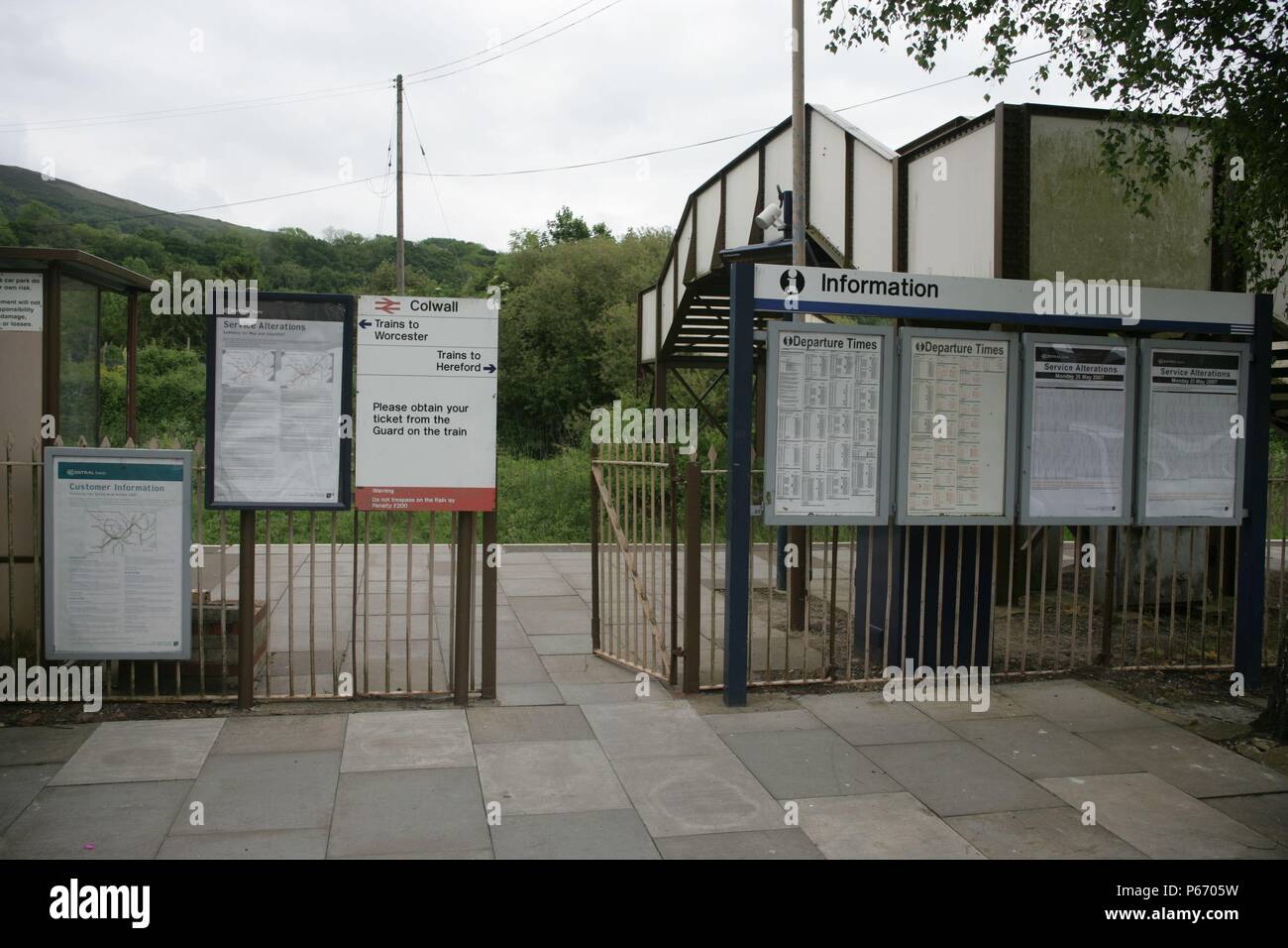 Station entrance with signs and timetables at Colwall, Worcestershire ...
