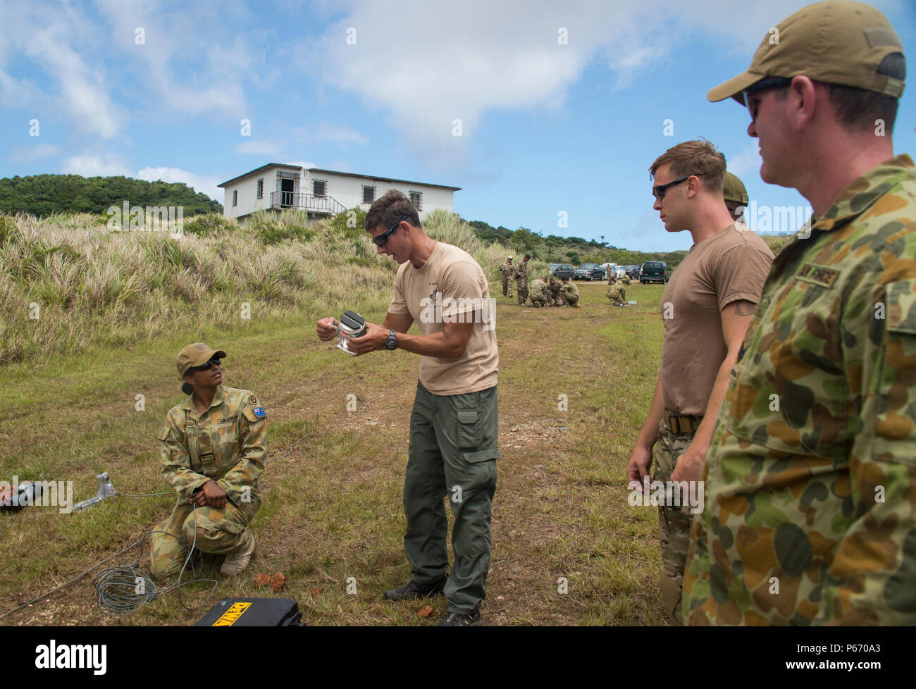 A U.S. Navy explosive ordnance disposal (EOD) technician, center ...