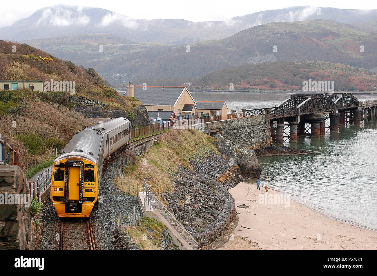 The Mawddach estuary is crossed by the famous Barmouth Bridge, under ...