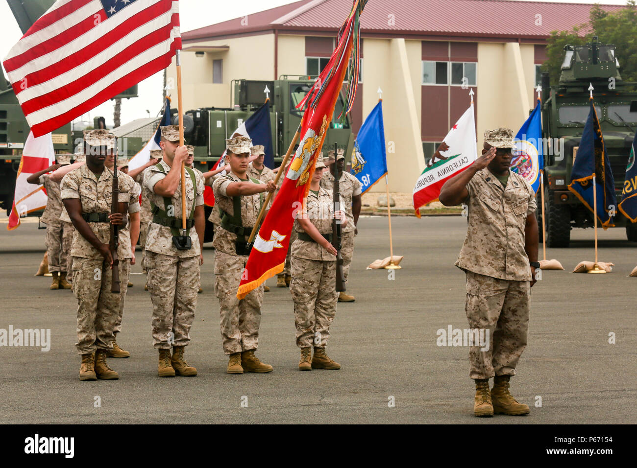U.S. Marine Master Sgt. Gregory Byrd salutes during the national anthem ...