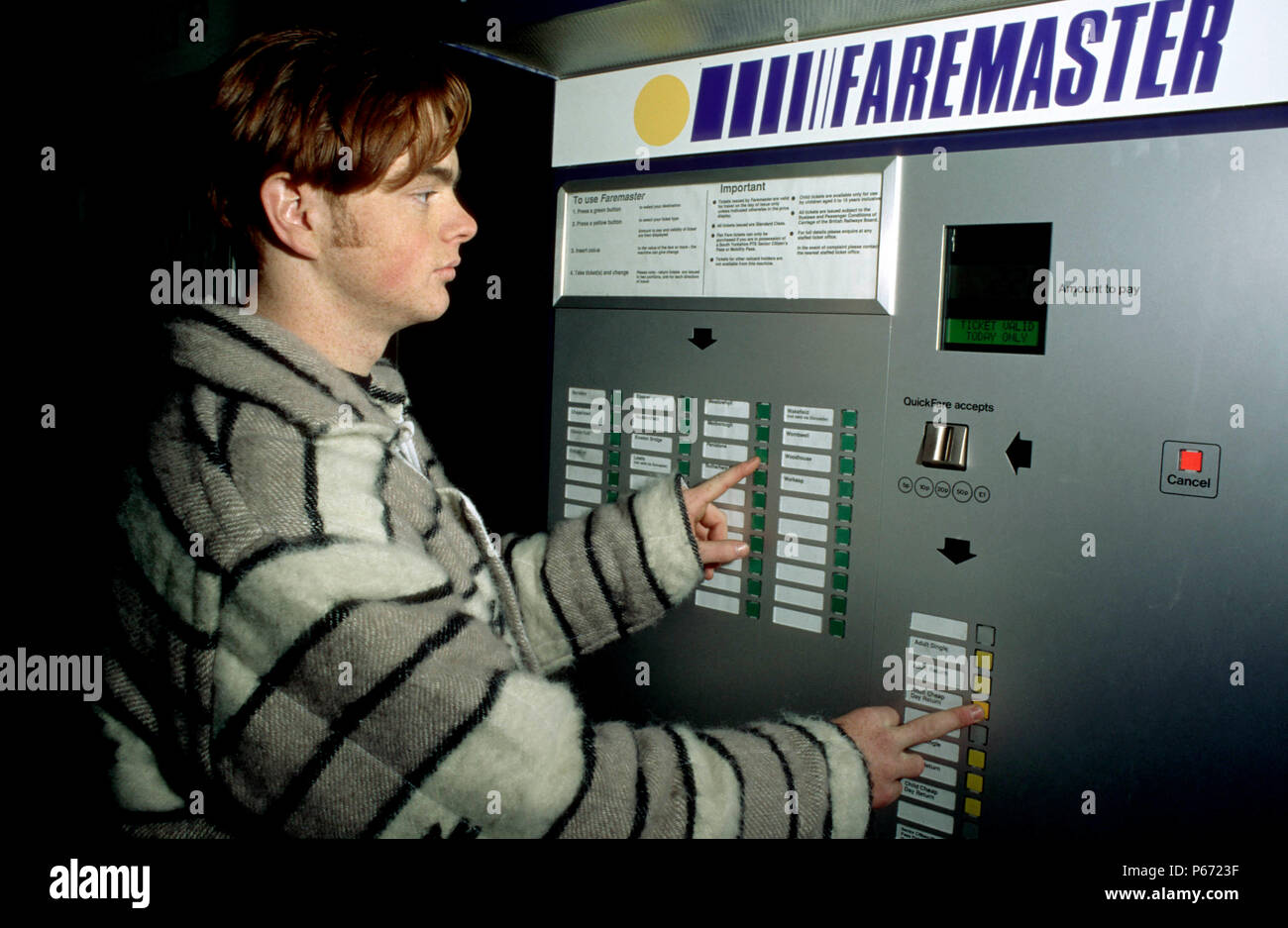 A passenger purchasing a ticket from a Faremaster automated ticket ...