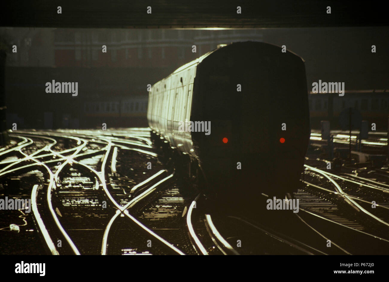 A train leaves Victoria Station in a moody scene Stock Photo - Alamy