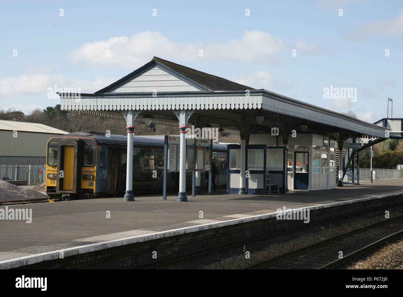 A train stands ready to depart on the Par to Newquay branch line at Par ...