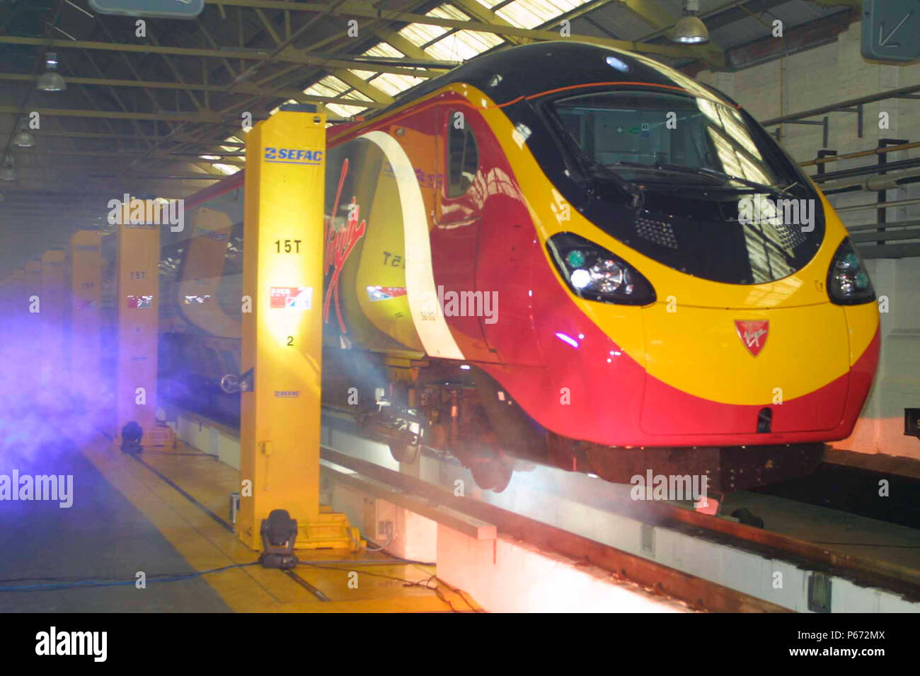 A Virgin Pendolino train is lifted of the tracks for maintainence work ...