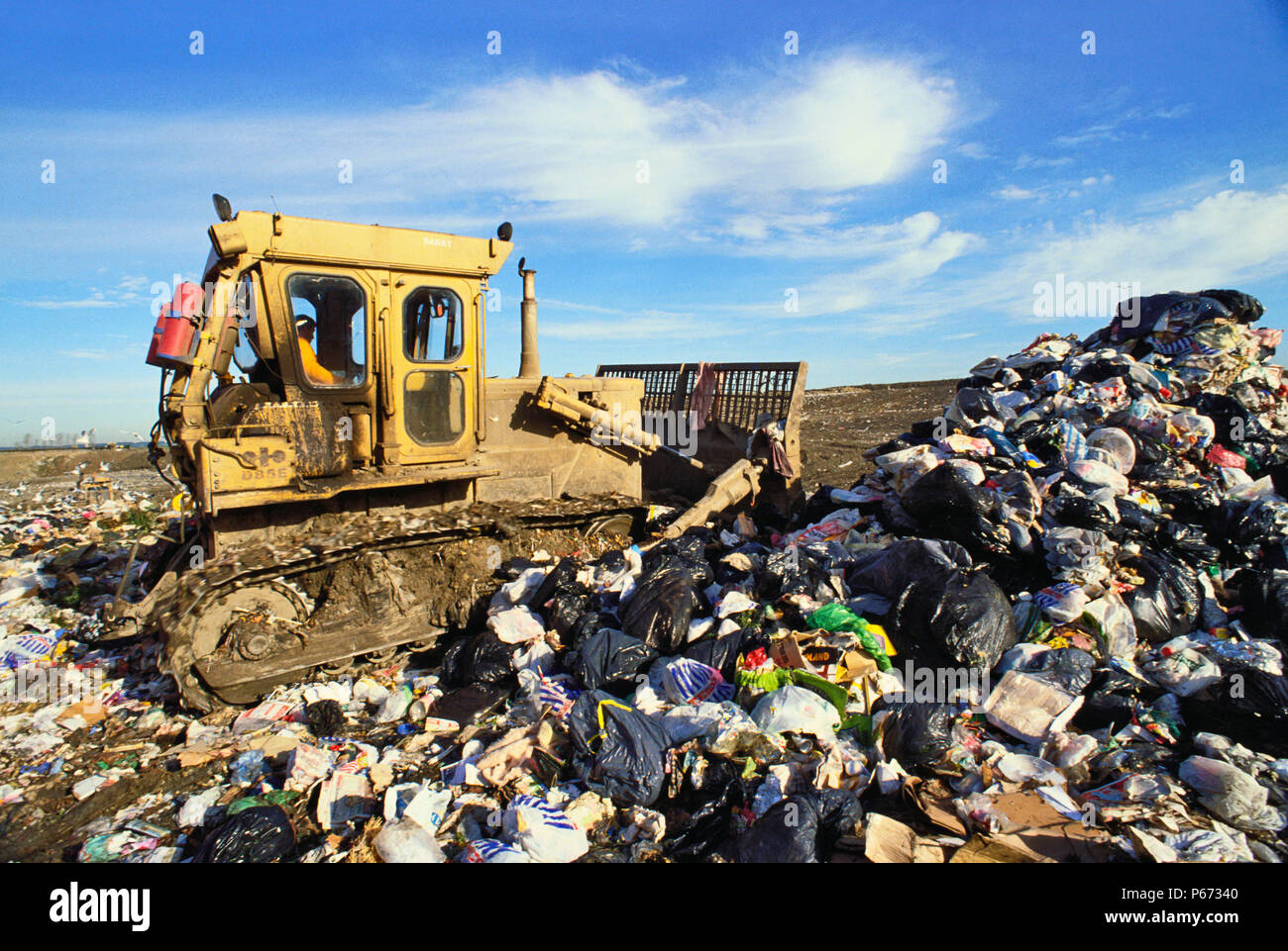 Bulldozer works on landfill site Stock Photo - Alamy