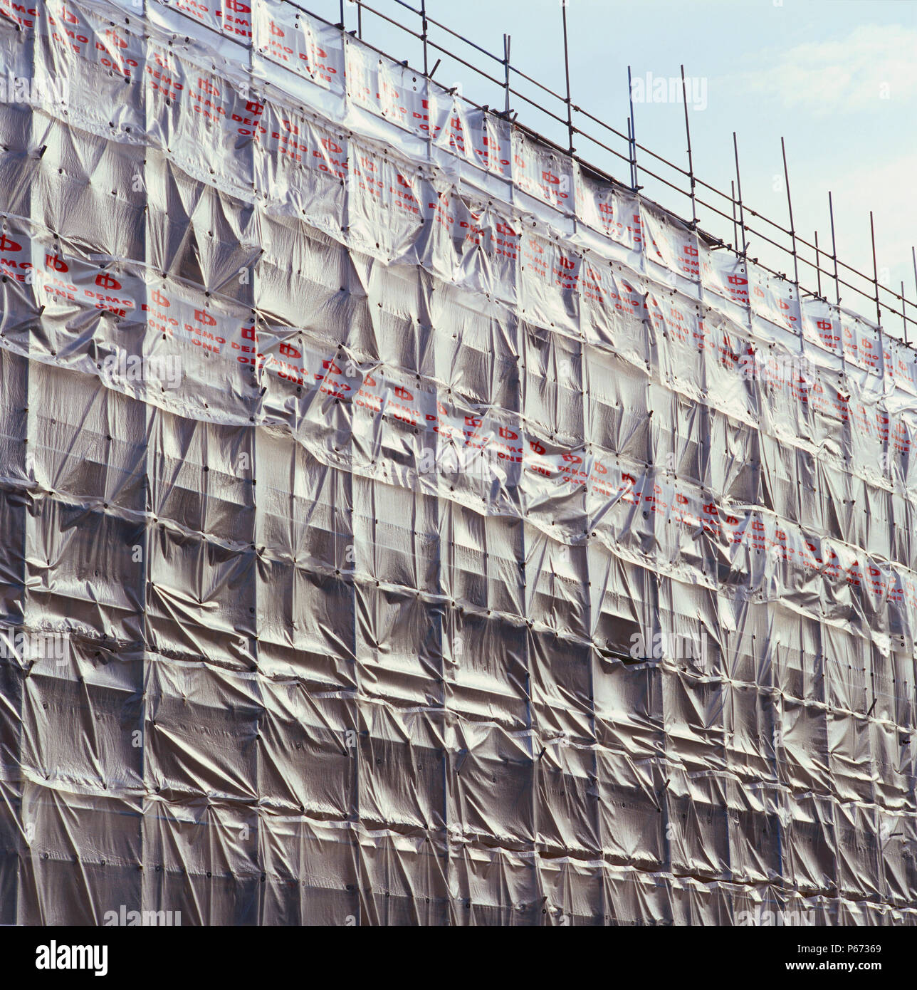 Temporary sheeting covers scaffolding erection during construction ...
