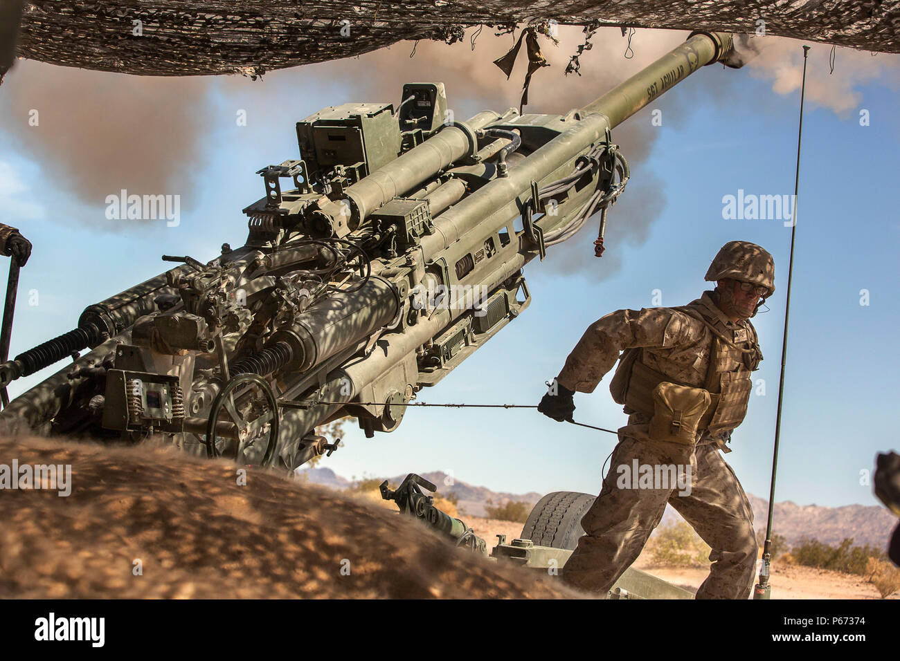 A Marine with 3rd Battalion, 11th Marine Regiment, fire a 155mm M777A2 ...