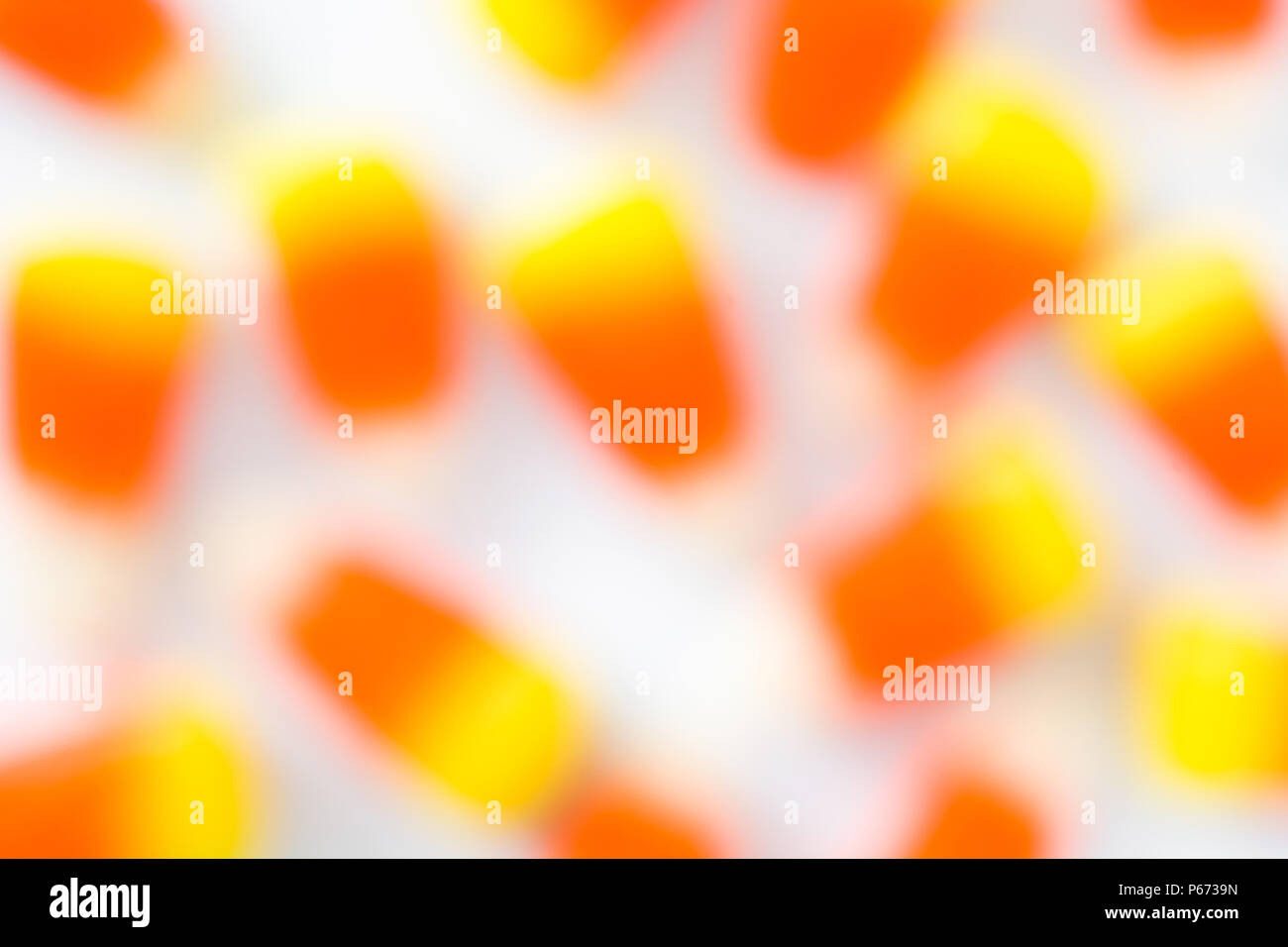 Typical halloween candy corn isolated blur background Stock Photo - Alamy